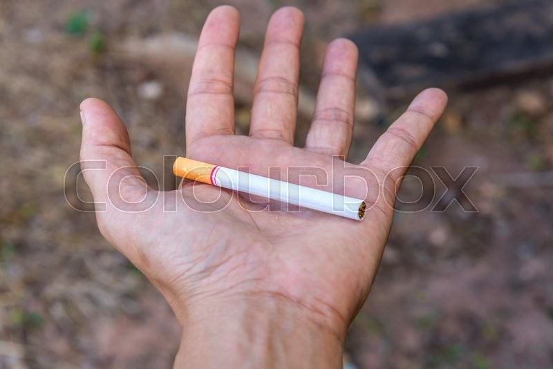Smoking cigarette with hand closeup in ... | Stock image | Colourbox