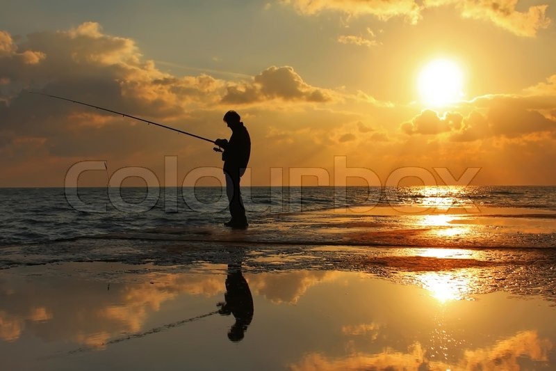 Fisherman standing on a pier at dawn ... | Stock image | Colourbox
