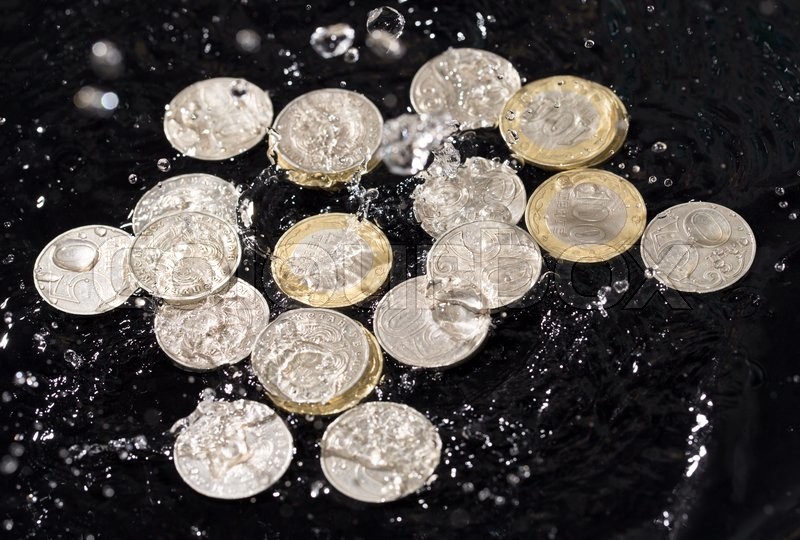 Coins in water splashes on a black ... | Stock Photo | Colourbox