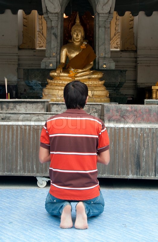 Man praying to budda in temple wat in ... | Stock image | Colourbox