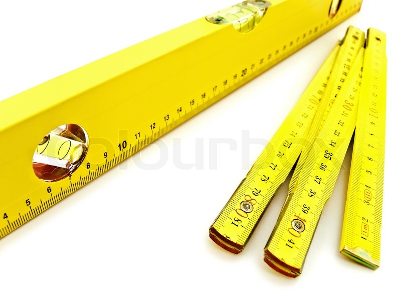 Yellow wooden meter and level over the ... | Stock image | Colourbox