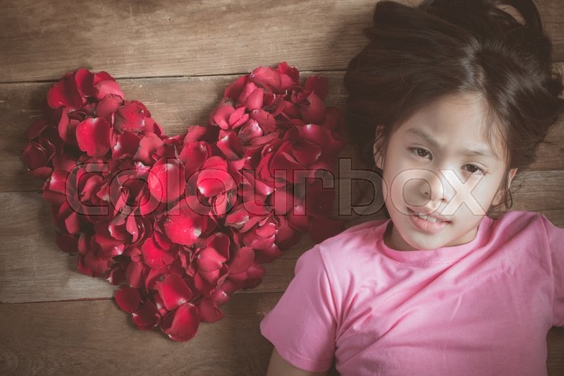 Lovely asian girl with red rose heart ... | Stock image | Colourbox