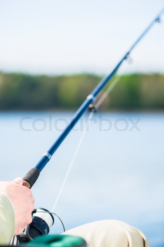 Man fishing with angle at lake, crop ... | Stock image | Colourbox