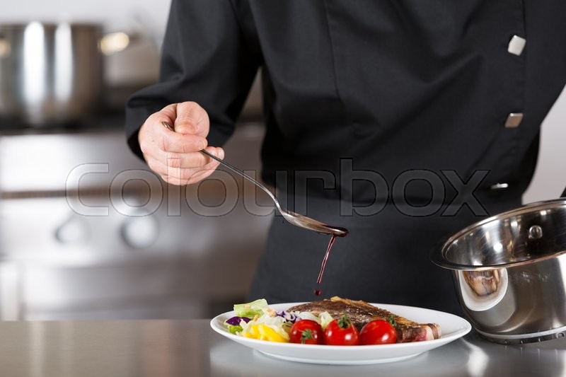 Chef finishing her plate and almost ... | Stock image | Colourbox