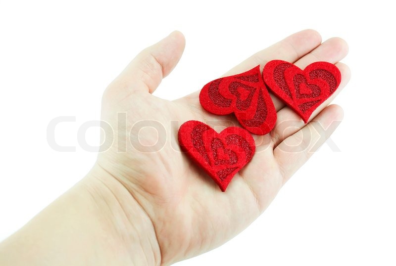 Men's hand holding three hearts ... | Stock image | Colourbox