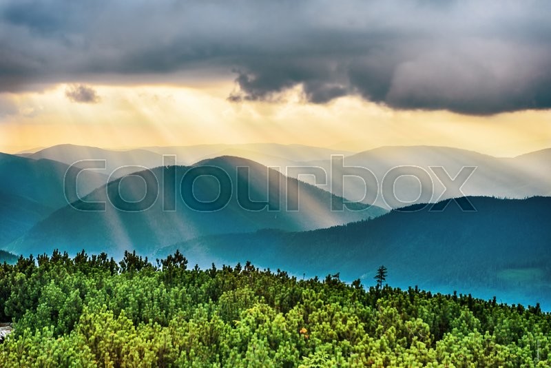 Sunset over blue mountains. Sun with ... | Stock Photo | Colourbox