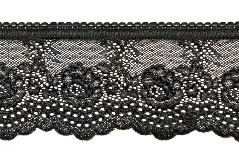 Black lace with pattern in the manner of flower on white background ...