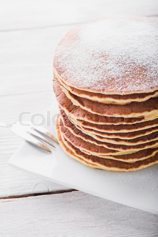 Stack of pancakes with powdered sugar ... | Stock image | Colourbox