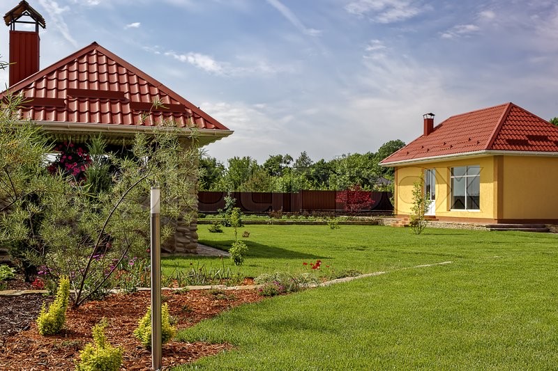 Green lawn and buildings in the ... | Stock Photo | Colourbox