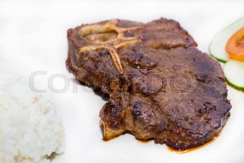 T Bone steak with rice and sauce on a ... | Stock image | Colourbox