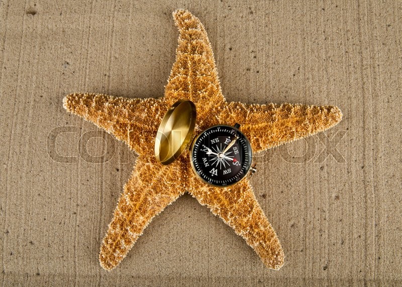 Starfish and compass on sand | Stock image | Colourbox