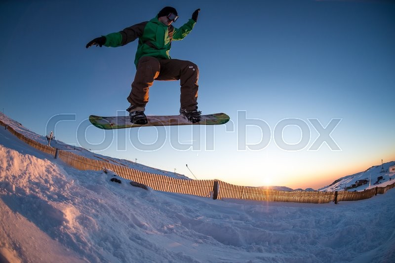 Young man snowboarding in the ... | Stock image | Colourbox