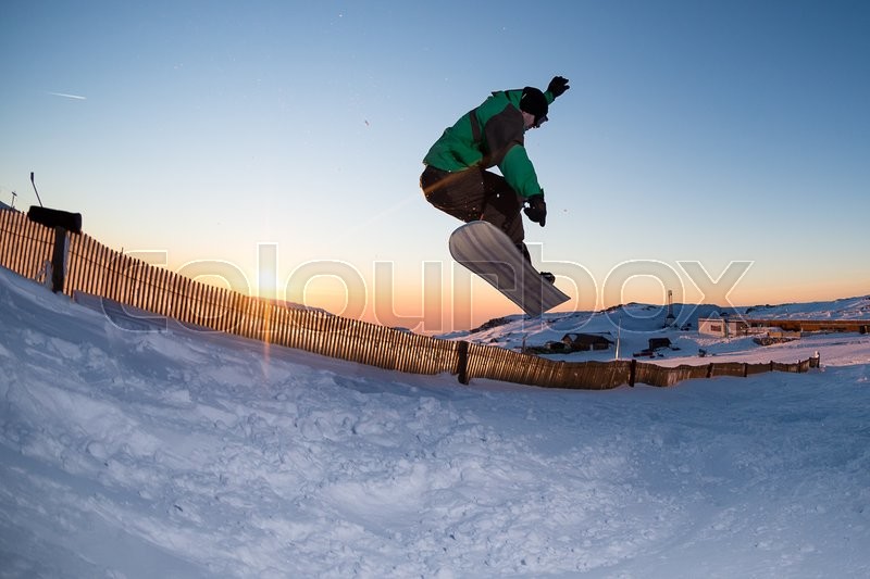 Young man snowboarding in the ... | Stock image | Colourbox