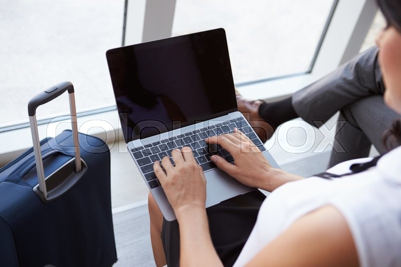 Businesswoman Using Laptop In Airport ... | Stock image | Colourbox