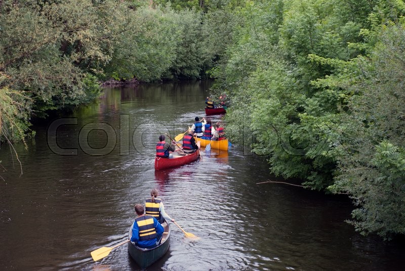 Canoeing on the river close to forest. | Stock image | Colourbox