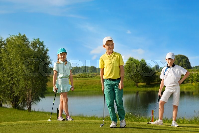 Kids playing golf by putter on green | Stock image | Colourbox