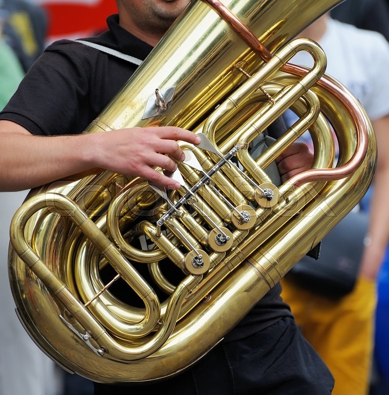 Musician is playing on the golden tuba. | Stock image | Colourbox