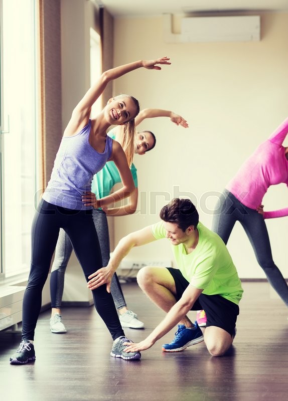 People Stretching At Gym