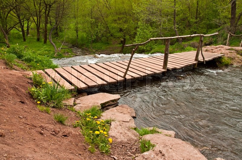 Wooden footbridge across river near ... | Stock image | Colourbox