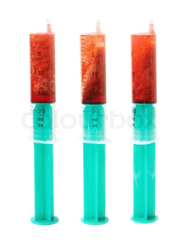 Medical syringe filled with red liquid ... | Stock image | Colourbox