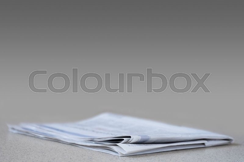 Newspaper on gray background with ... | Stock image | Colourbox
