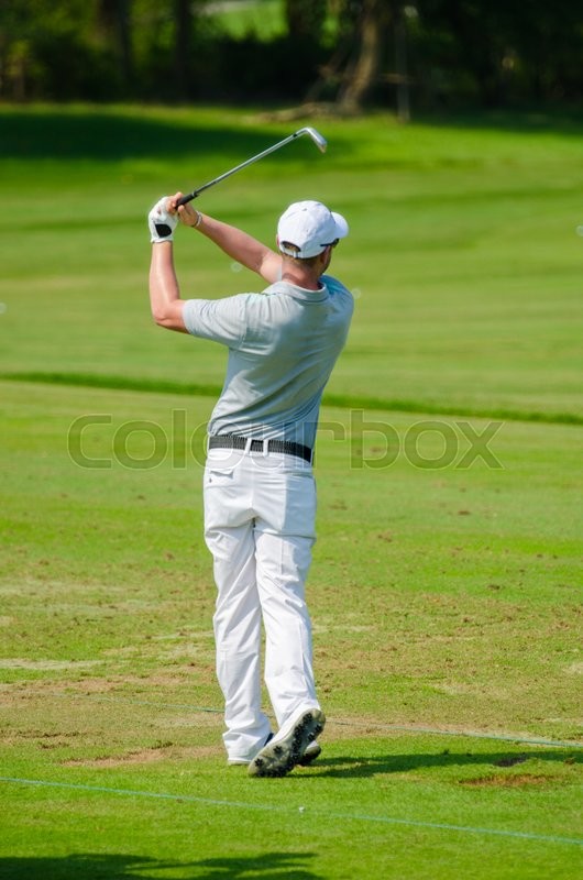 Golfer hitting golf shot on summer ... | Stock image | Colourbox