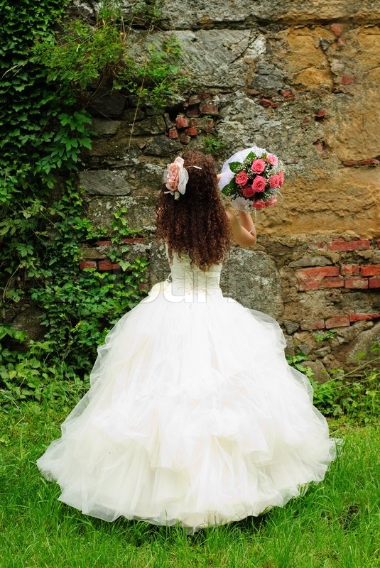 Bride from behind throw the bouquet ... | Stock Photo | Colourbox