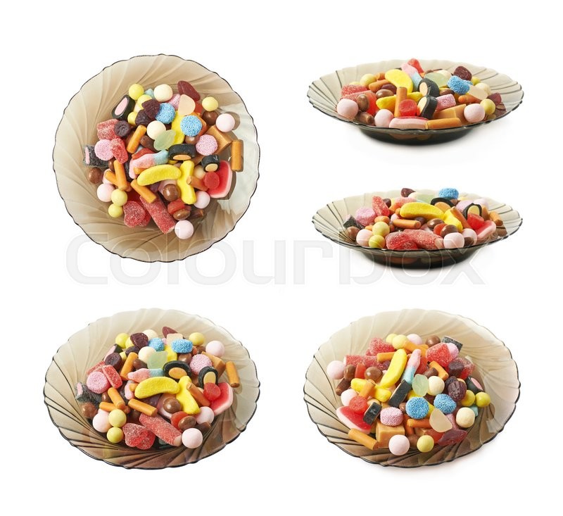 Glass plate full of candies isolated ... | Stock image | Colourbox