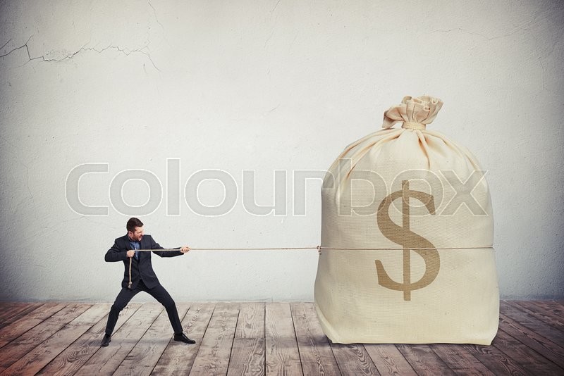 Man pulling on a rope big bag of money, ... | Stock image | Colourbox