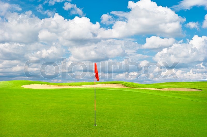 Green golf field with cloudy sky ... | Stock image | Colourbox