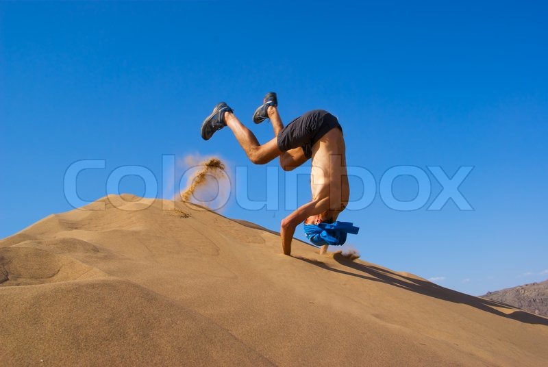 Fun jumping on sand dune | Stock image | Colourbox
