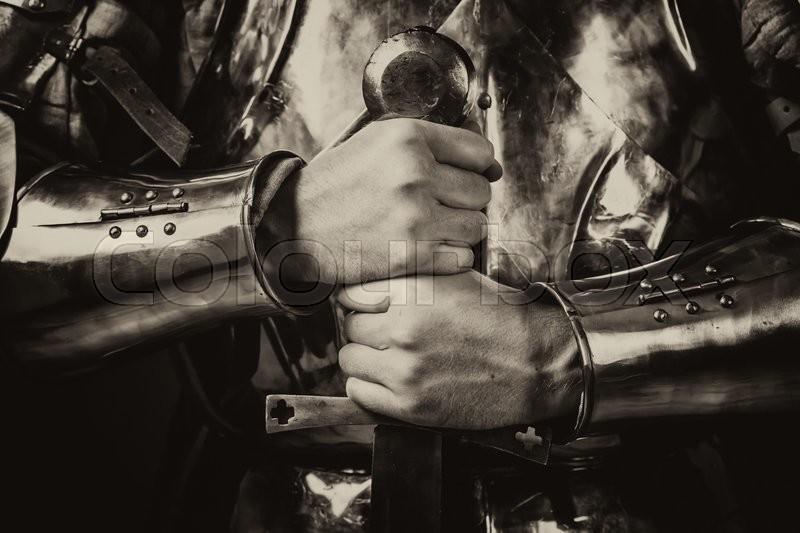 Knight wearing armor and holding ... | Stock image | Colourbox