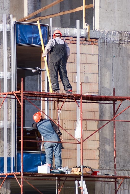 A construction worker on a high wall | Stock image | Colourbox