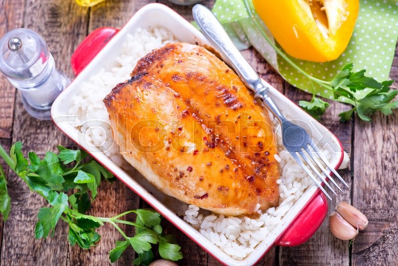 Chicken fillet on plate and on a table | Stock image | Colourbox