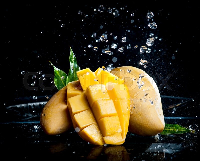 Mango splashing over clear water on ... | Stock image | Colourbox