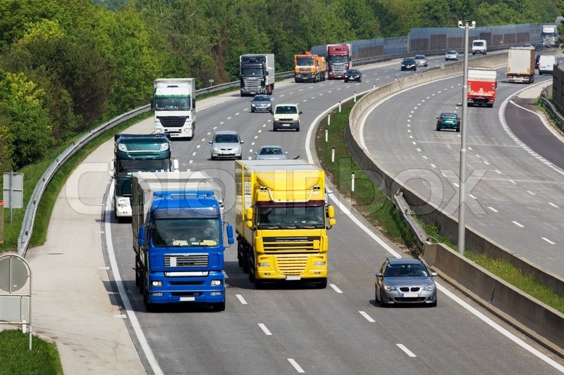 On a highway trucks and cars driving side by side. | Stock Photo ...