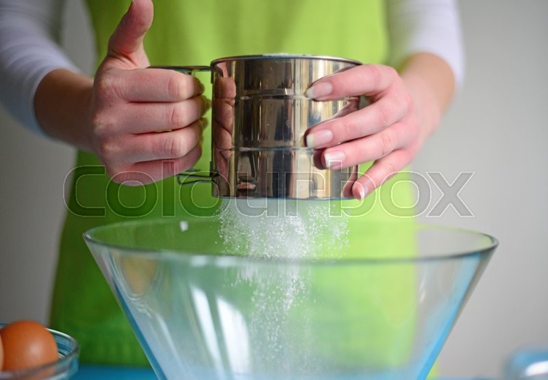 Flour sifting through a sieve for a ... | Stock image | Colourbox
