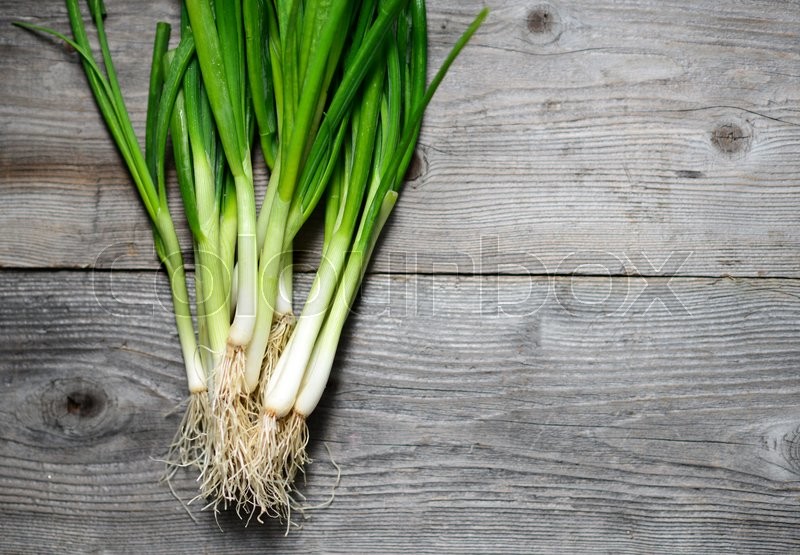 Fresh spring onion on wooden background | Stock image | Colourbox