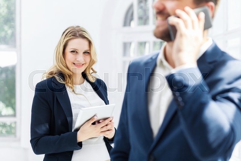 The smiling male and female office ... | Stock image | Colourbox