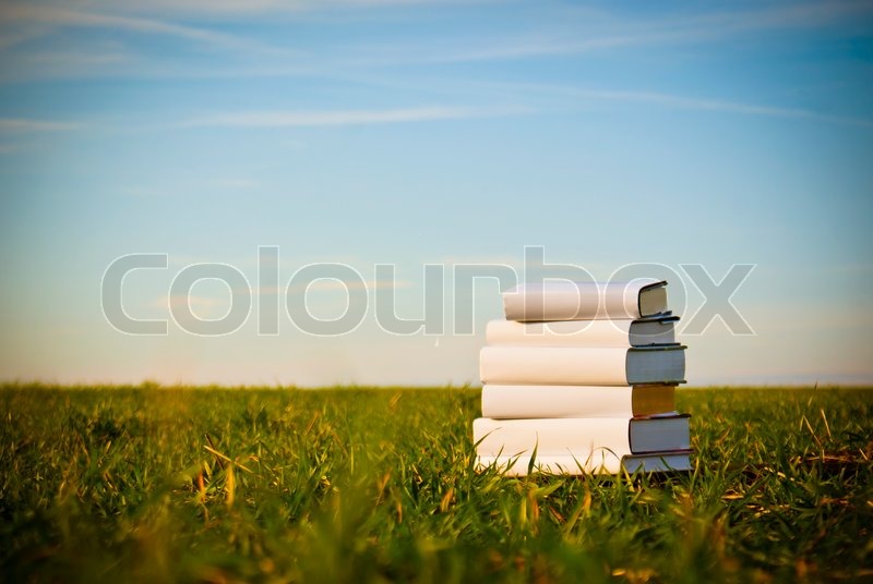 Books laying on grass | Stock image | Colourbox