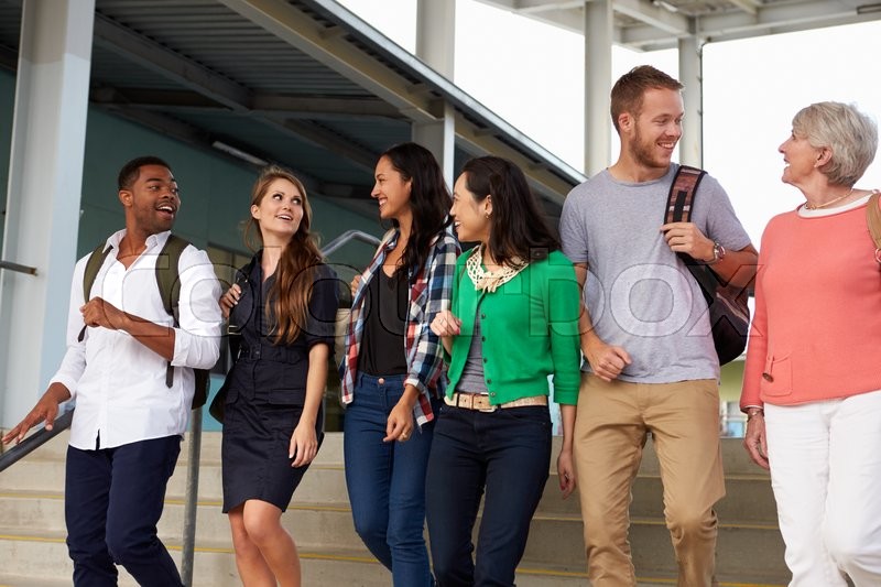 A group of happy teachers walking in a ... | Stock image | Colourbox