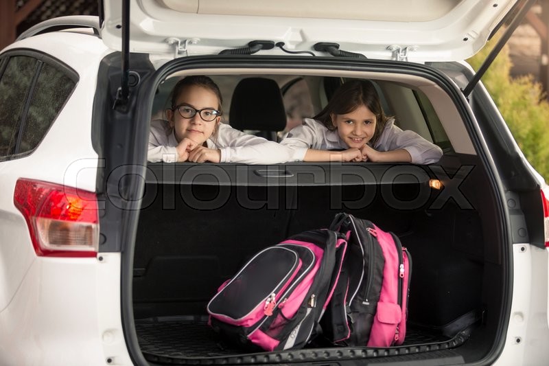 Two cheerful girls sitting in car ... | Stock image | Colourbox