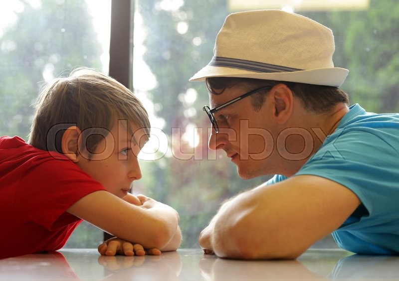 Father and son look at each other, ... | Stock image | Colourbox