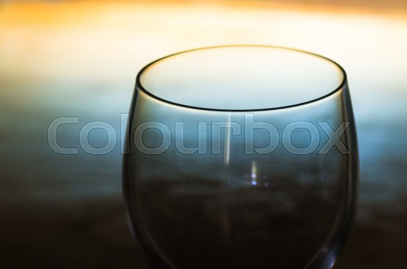 An empty wine glass in a dark room soft ... | Stock image | Colourbox