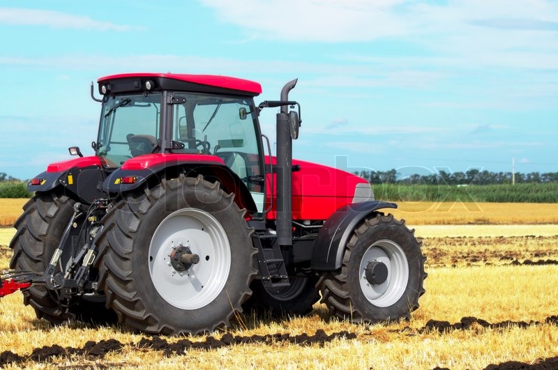 Tractor in a field, an exhibition of modern technology | Stock Photo ...