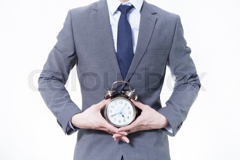 Man in Business Suit holding a clock - ... | Stock image | Colourbox