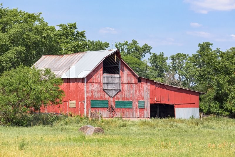 A rustic old red barn stands on a farm ... | Stock image | Colourbox