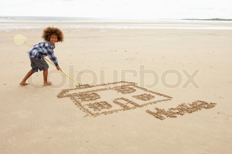 Boy drawing in sand | Stock image | Colourbox
