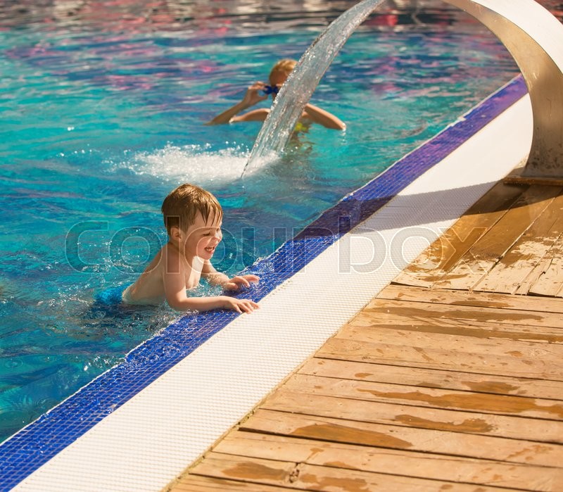 Little boy playing in swimming pool in ... | Stock image | Colourbox