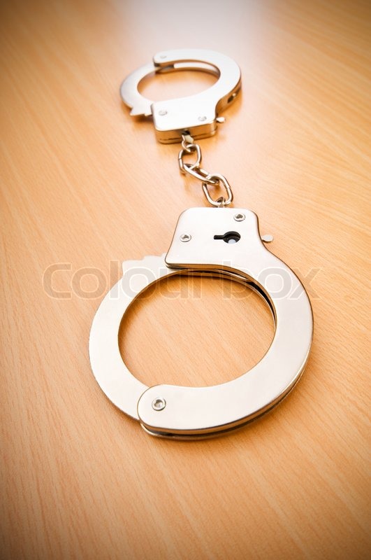 Metal handcuffs on the wooden ... | Stock Photo | Colourbox